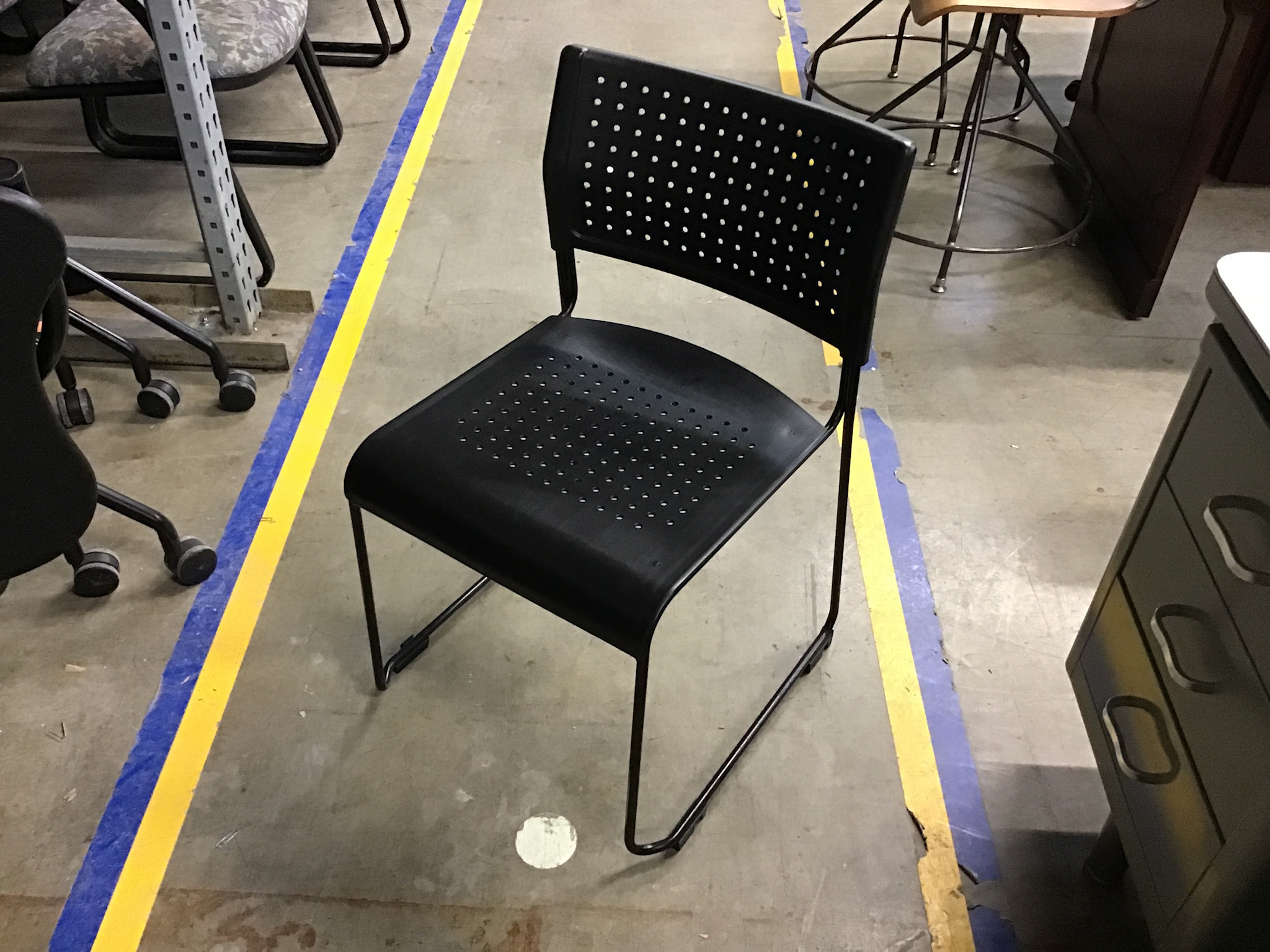Black plastic stacking chair 12/18/25 - ND Surplus